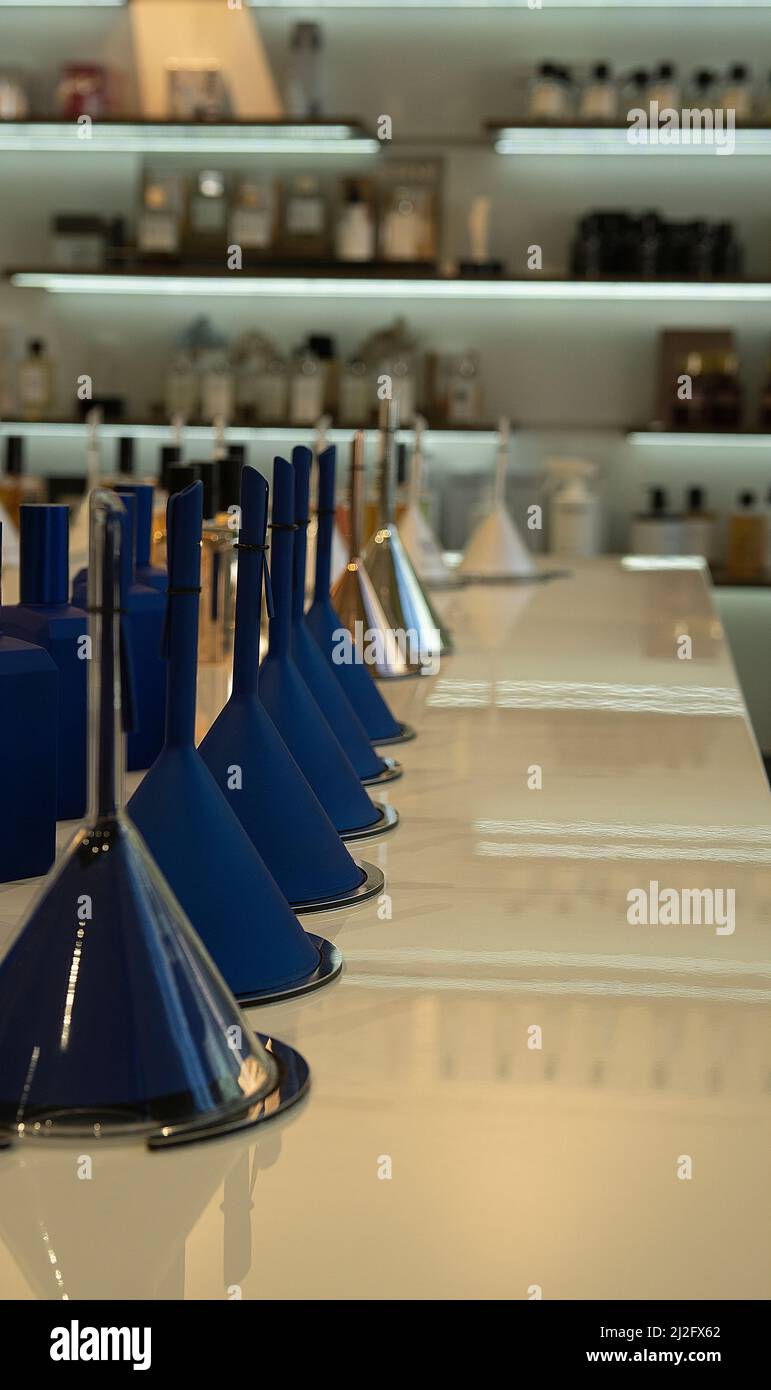 Perfume bottles and funnels with fragrance on the counter in a luxury ...