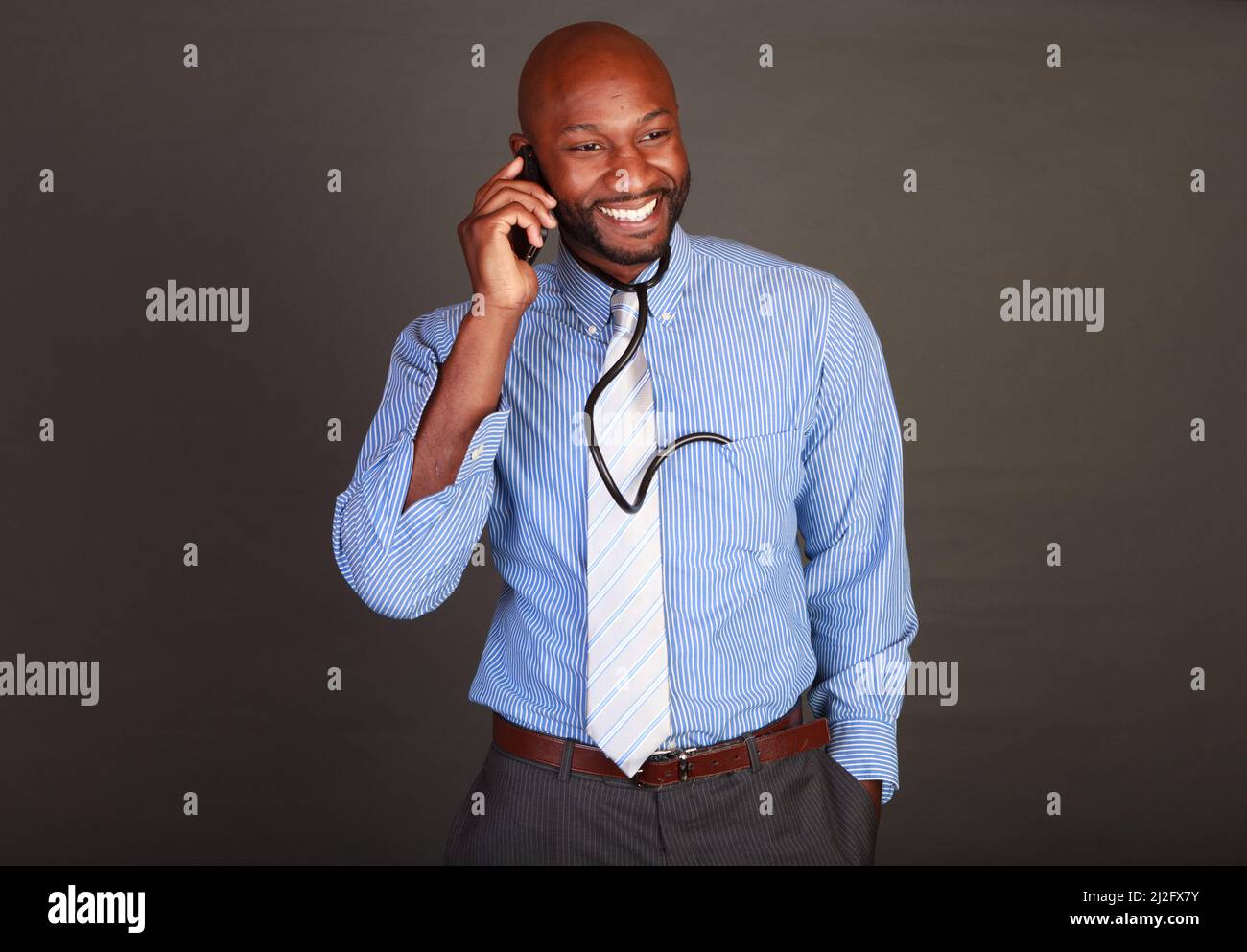 African American / Black doctor checking his cell phone Stock Photo - Alamy