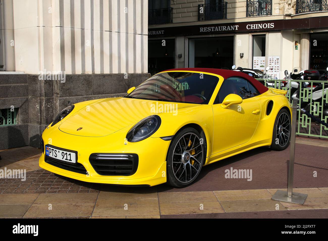 A yellow coloured Ferrari parked outside a hotel in Nice Stock Photo ...