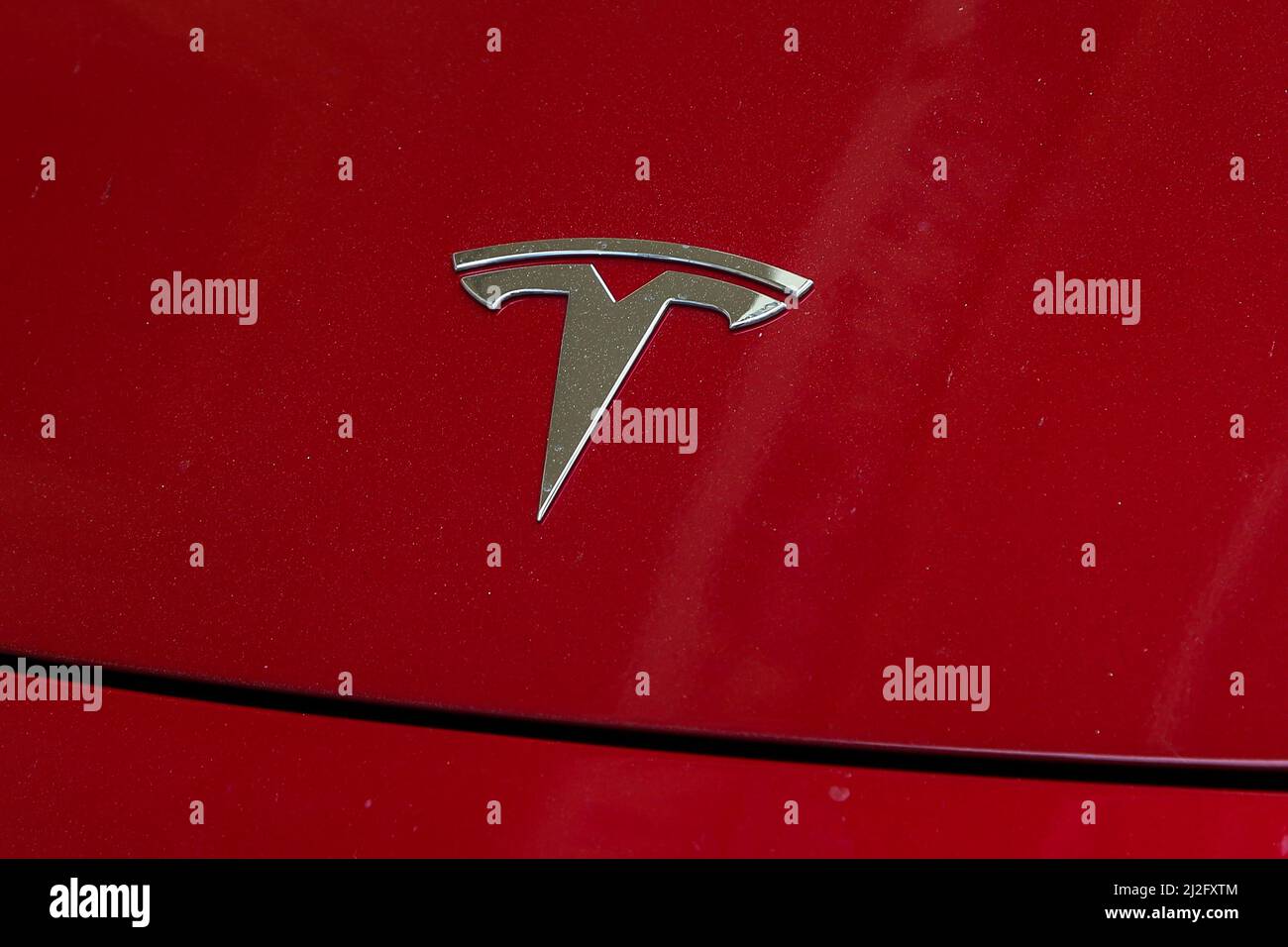 Tesla's logo seen on a red Tesla car in the city centre of Nice Stock ...