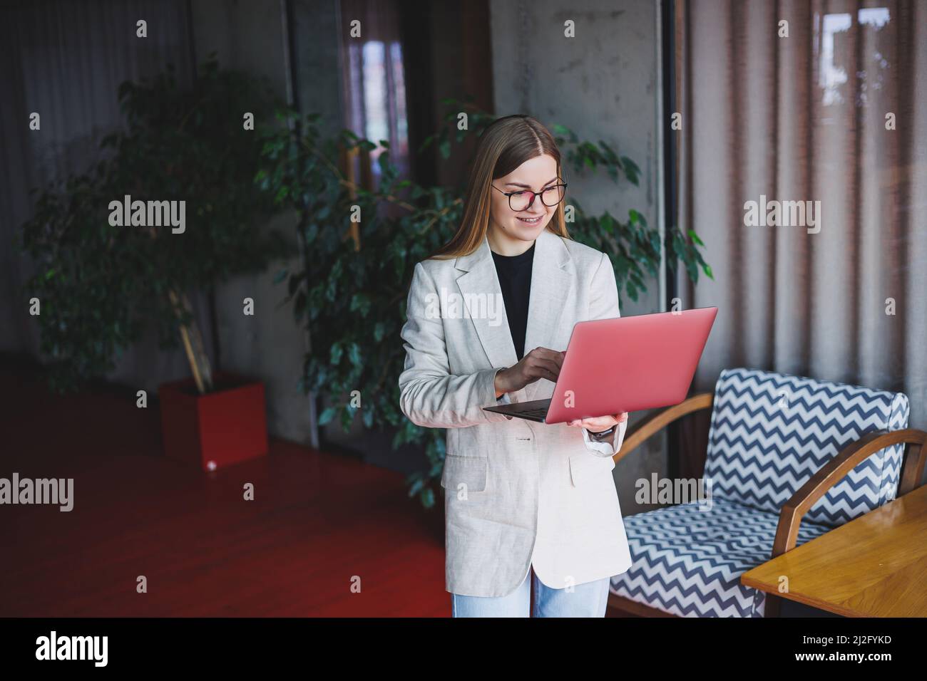 Female administrative manager in glasses and formal suit walking to ...