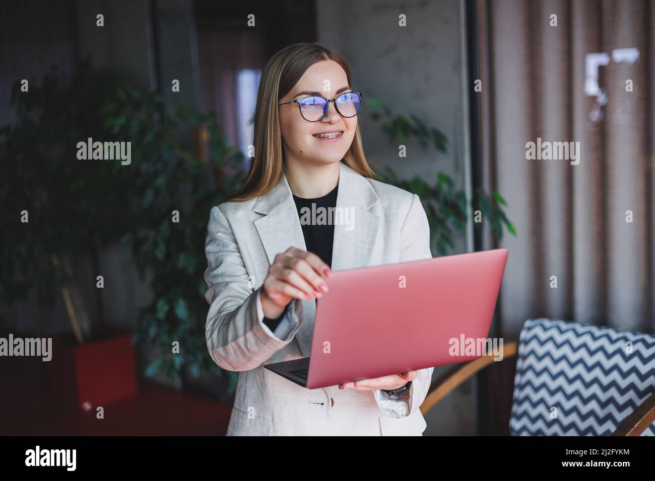 Female administrative manager in glasses and formal suit walking to ...