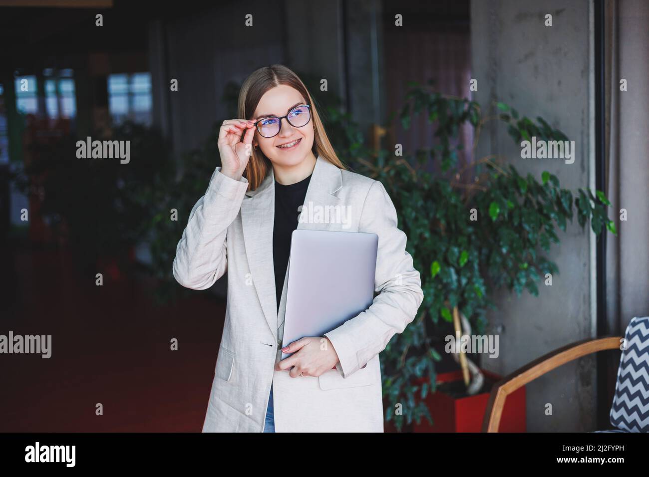 Portrait of a successful manager in the office smiling in during the ...