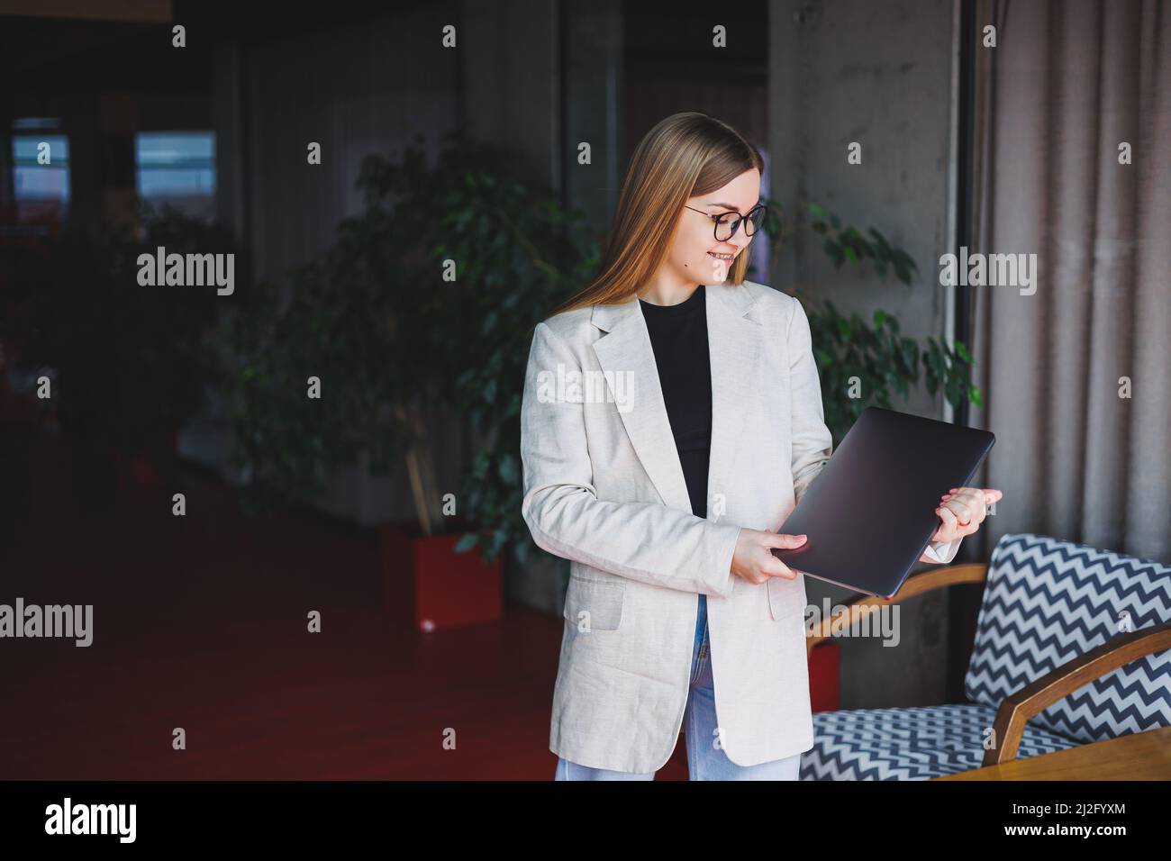 Portrait of a successful manager in the office smiling in during the ...