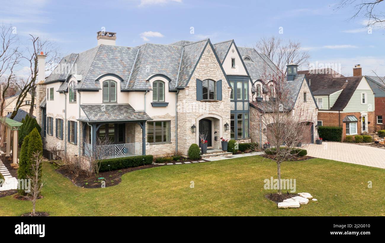 A beautiful, luxurious home with rock siding, arched windows and ...