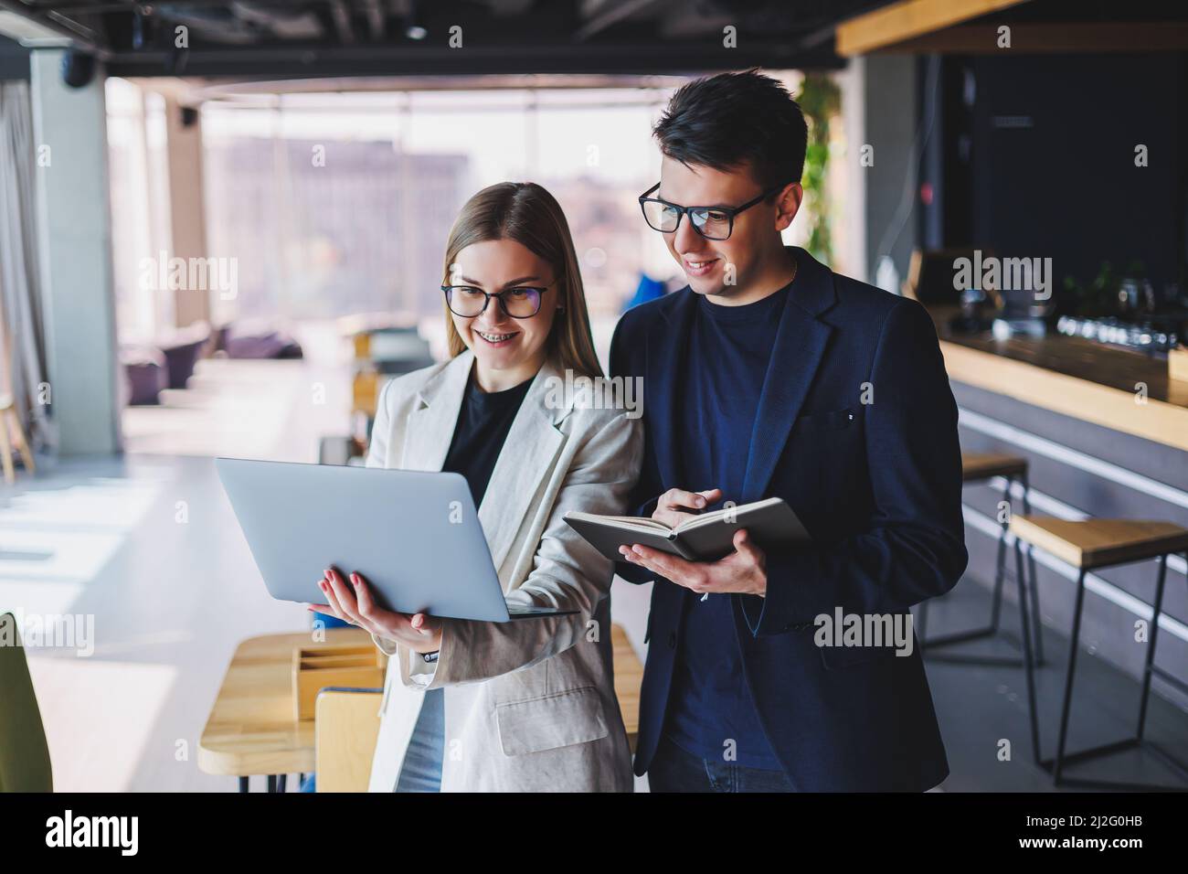 Beautiful european business woman and business man looking at the ...