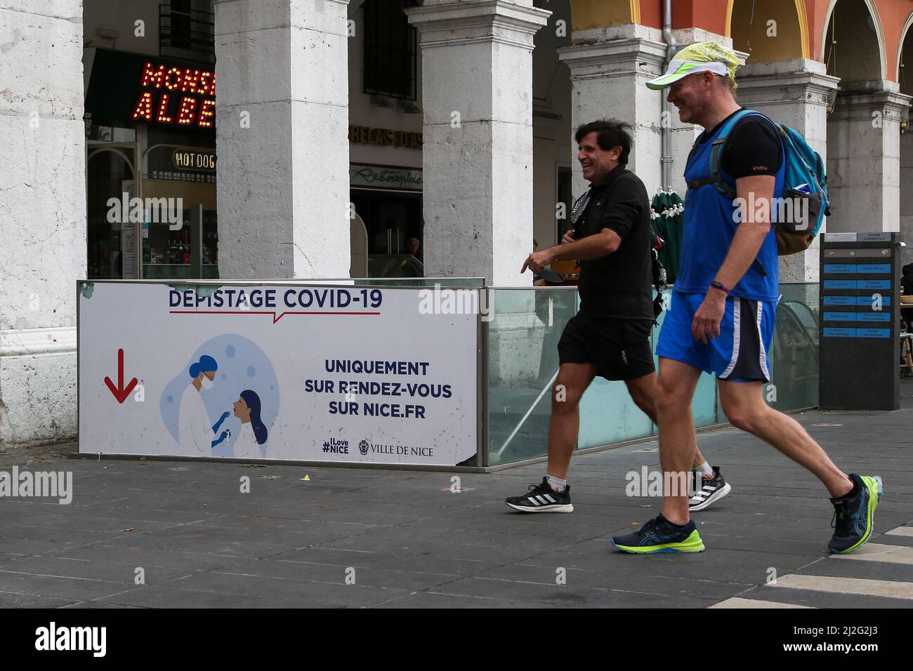 Men walk past signs hi-res stock photography and images - Alamy