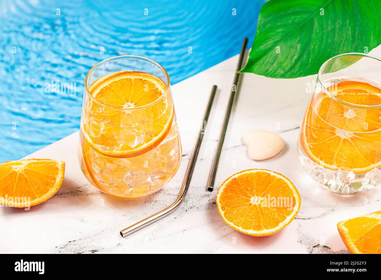 Summer refreshing water with orange slice. Glass of cocktail, orange ...