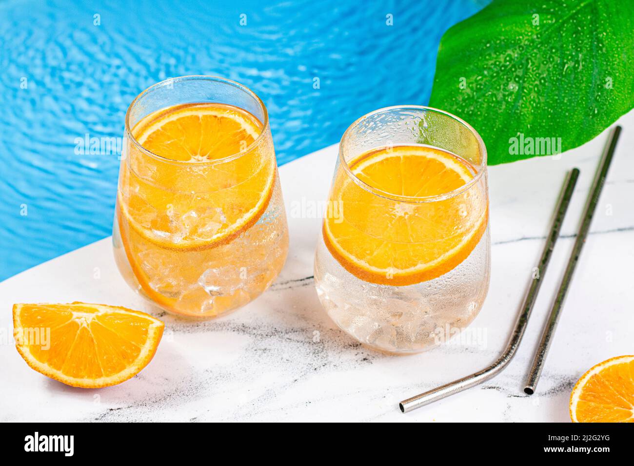 Summer refreshing water with orange slice. Glass of cocktail, orange ...