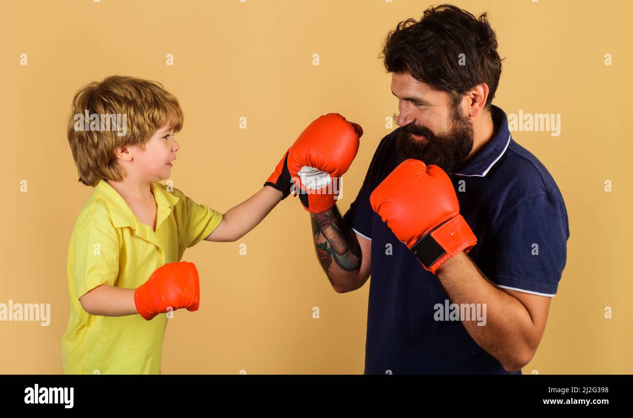 Father and son during boxing training. Child boy boxer in gloves ...