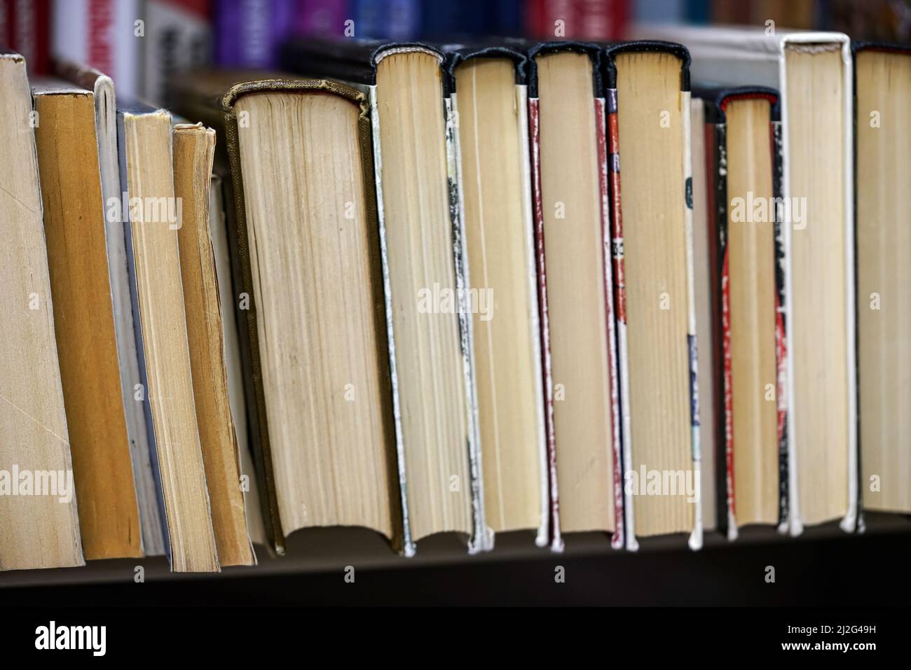 Row of many old used books displayed at local antiquarian bookshop ...