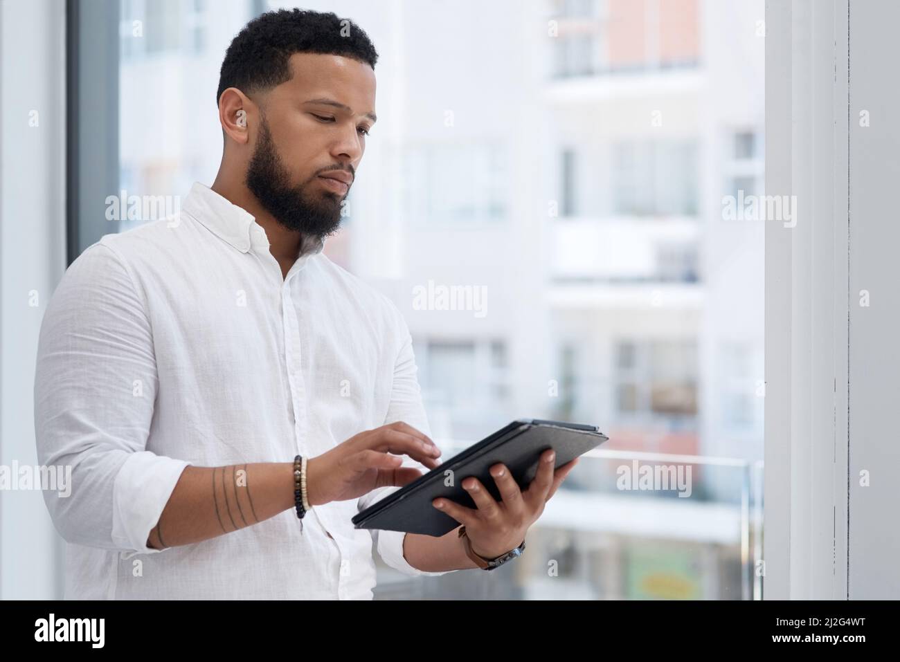 Staying efficient while handling tasks. Shot of a young businessman ...