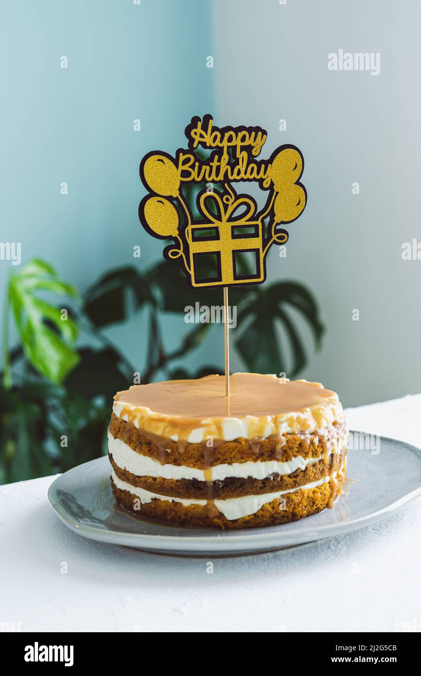 Cake with Birthday topper. Copy space. Blurred background. Vertical ...