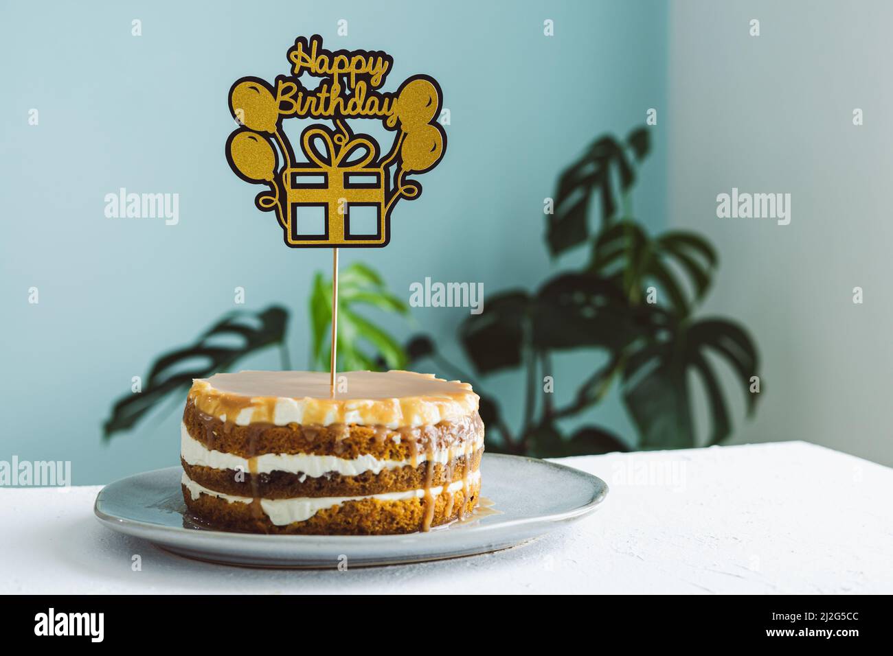 Cake with Birthday topper. Copy space. Blurred background Stock Photo ...