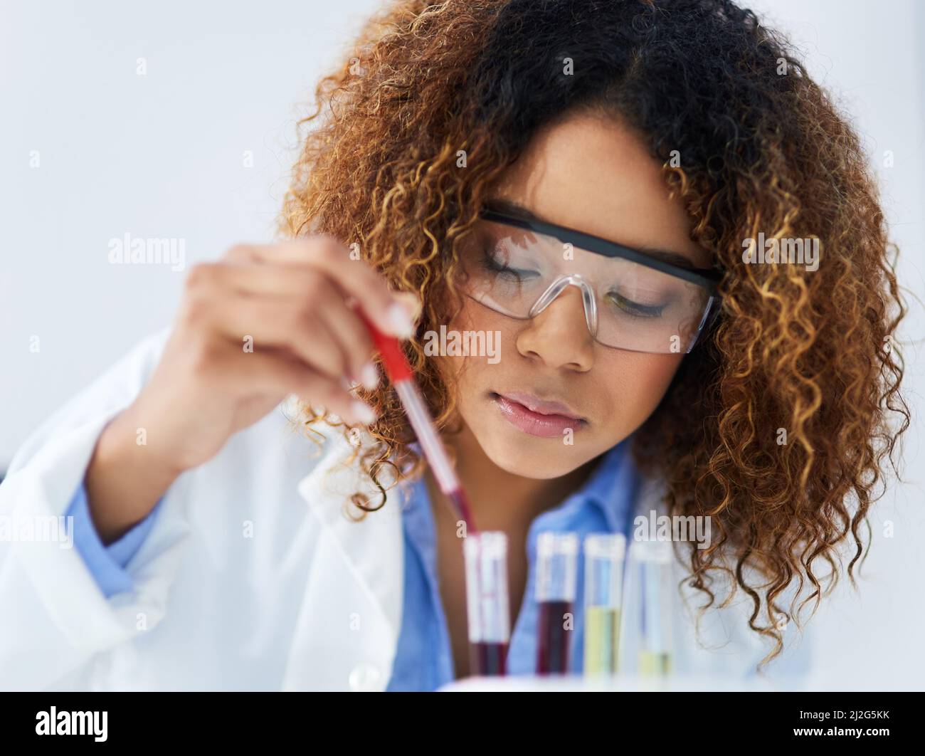Testing each one individually. Cropped shot of a young female scientist ...
