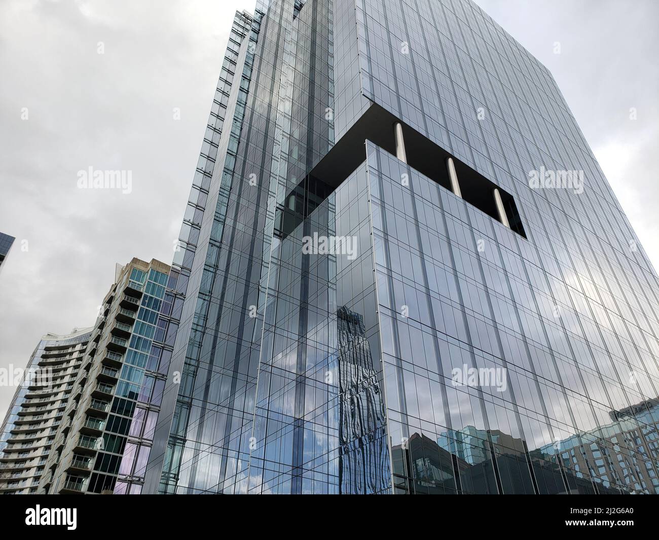 A low angle shot of a modern building with glass windows Stock Photo ...