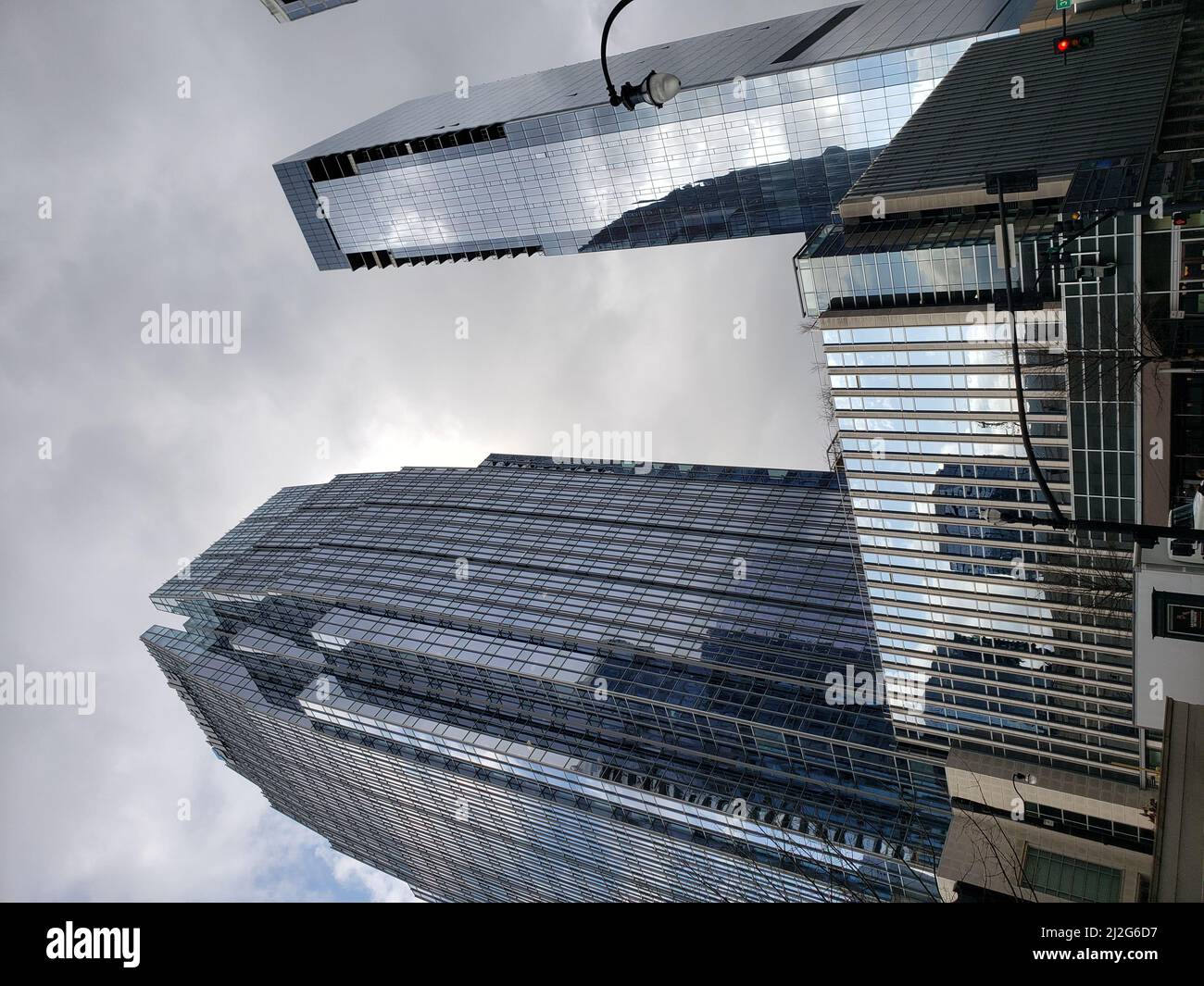 A vertical low angle shot of modern buildings with glass windows Stock ...