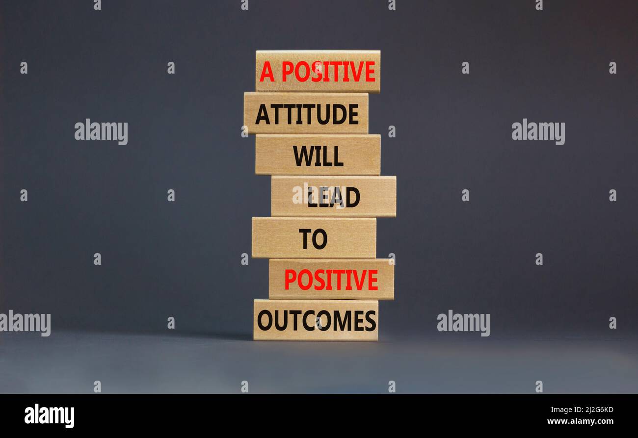 Think positive symbol. Wood blocks with words A positive attitude will ...