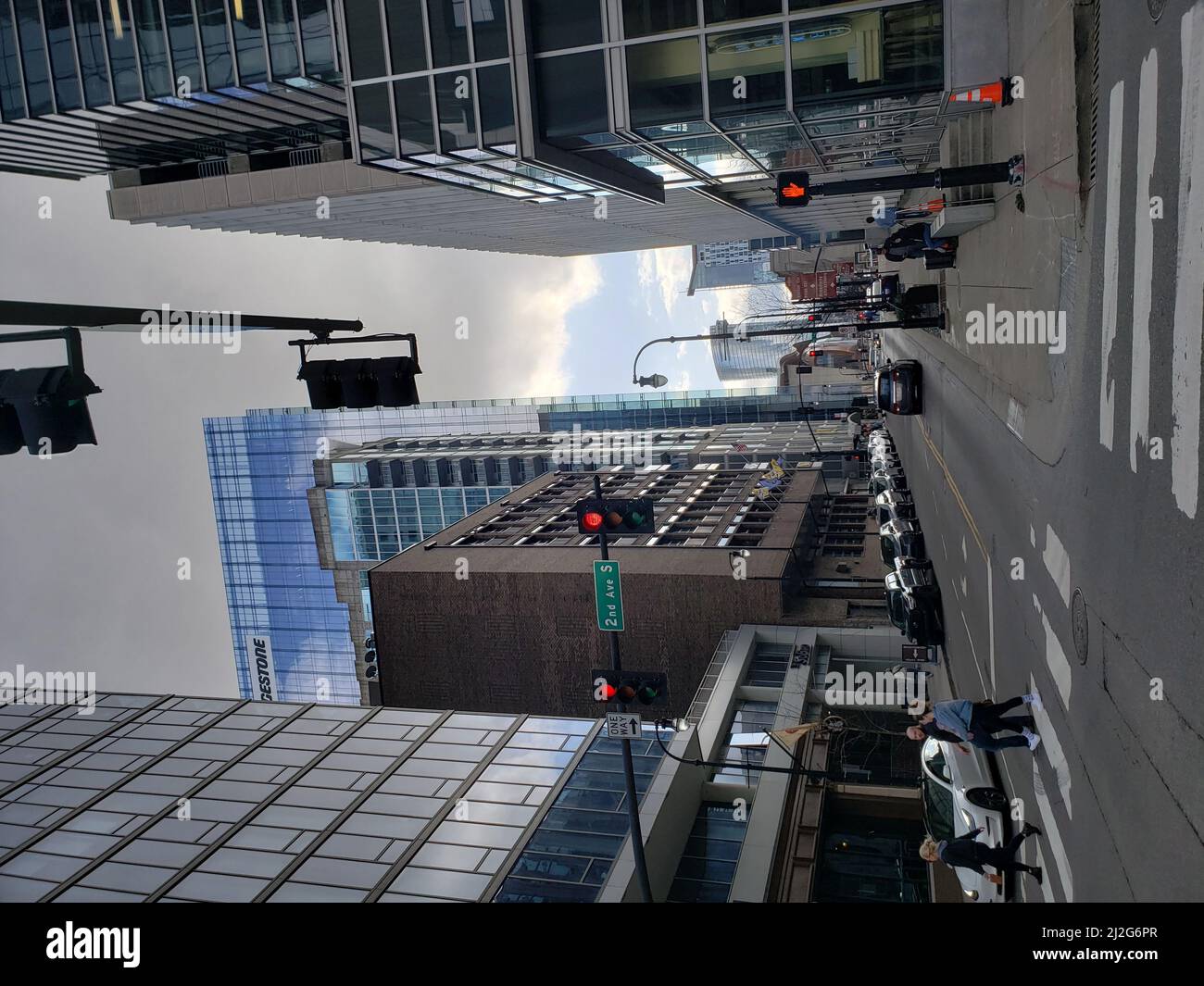 A vertical low angle shot of a street with modern buildings with glass ...