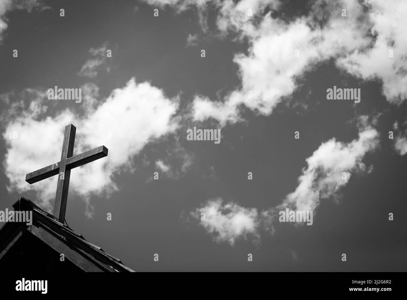 A grayscale shot of a cross on the roof of the Chapel of the ...