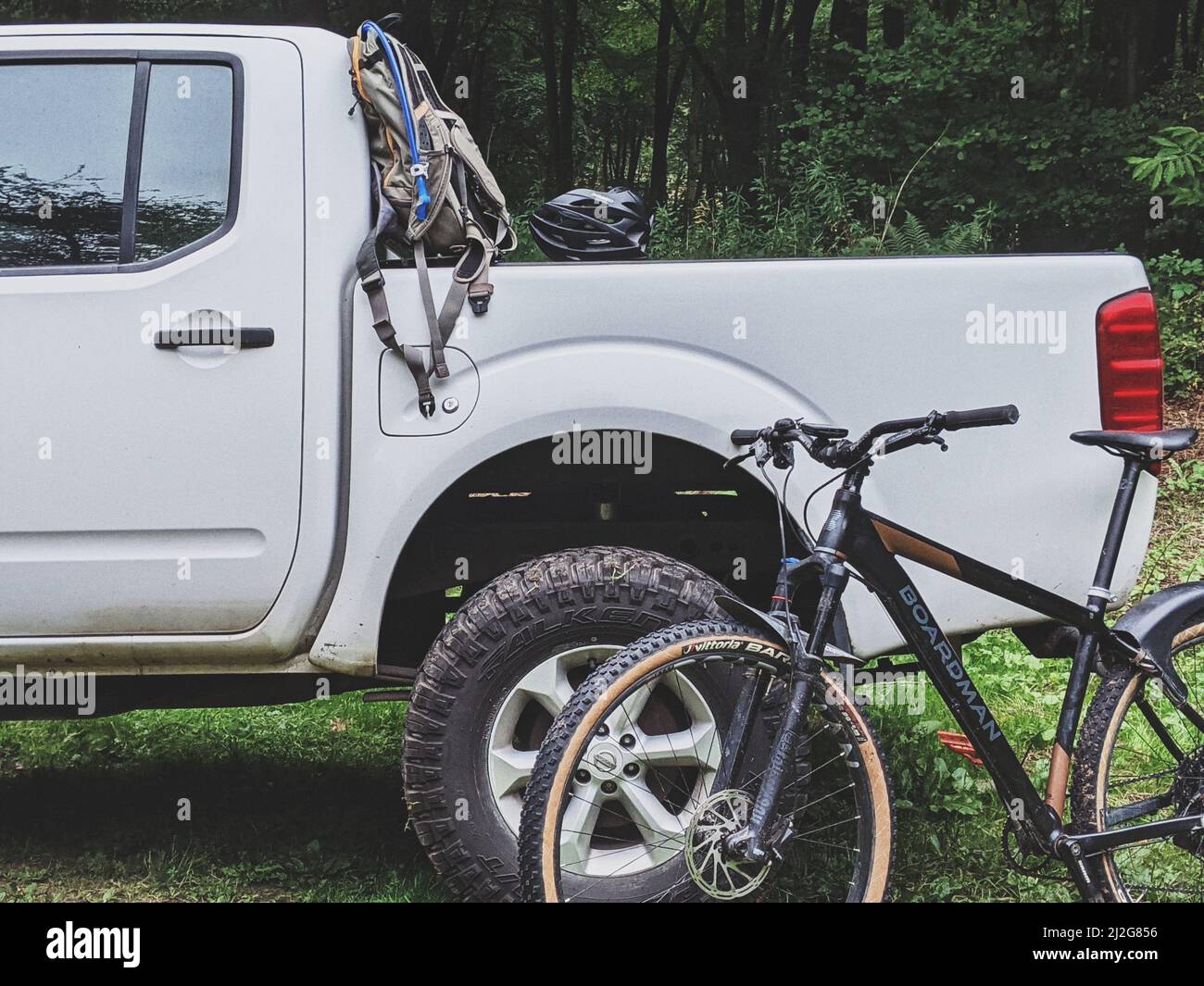 A white pickup truck and a mountain bike in the forest Stock Photo - Alamy