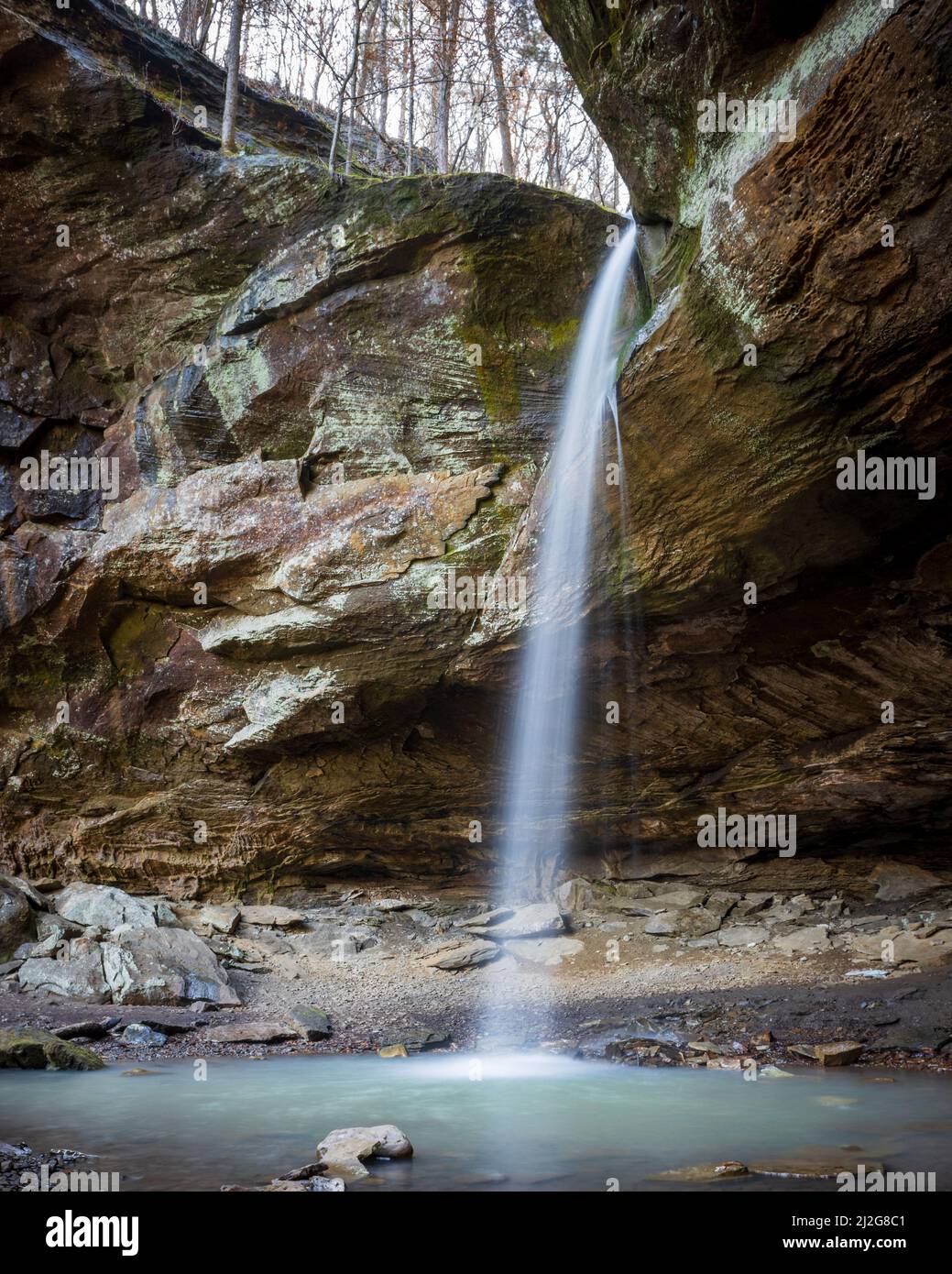 A scenic view of a falling water coming out from the rocks Stock Photo ...