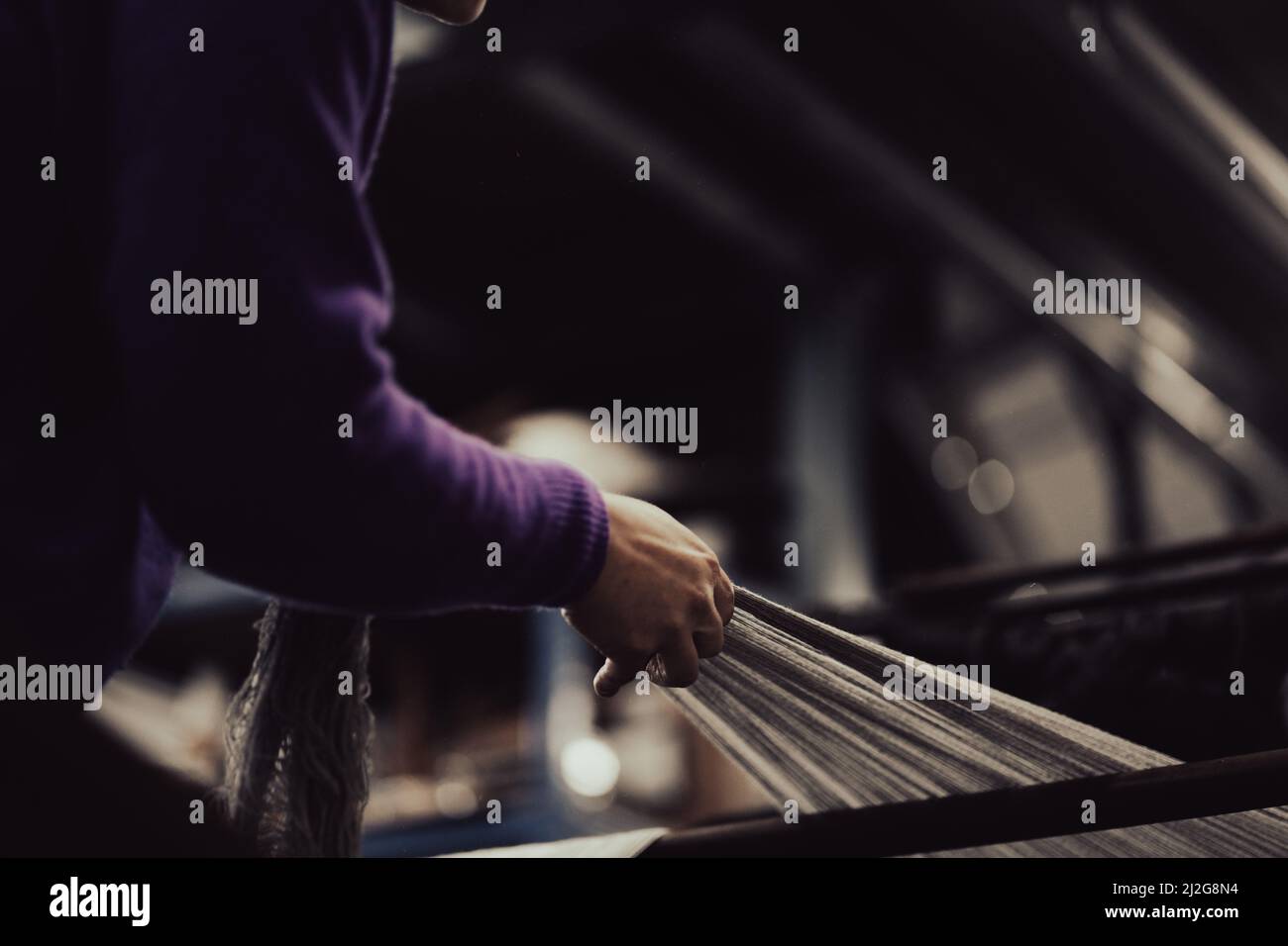Weaving the threads of the loom Stock Photo - Alamy