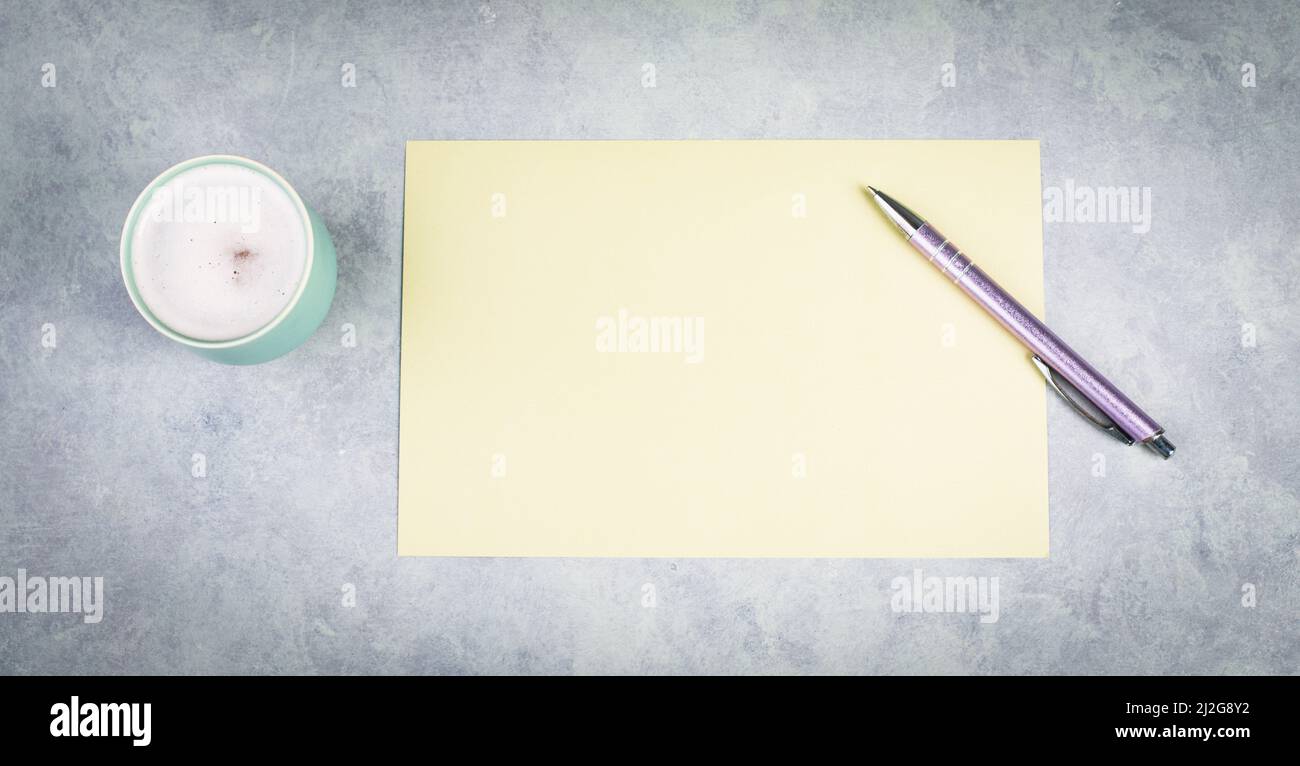 Empty paper with a pen and a cup of coffee, textured background ...