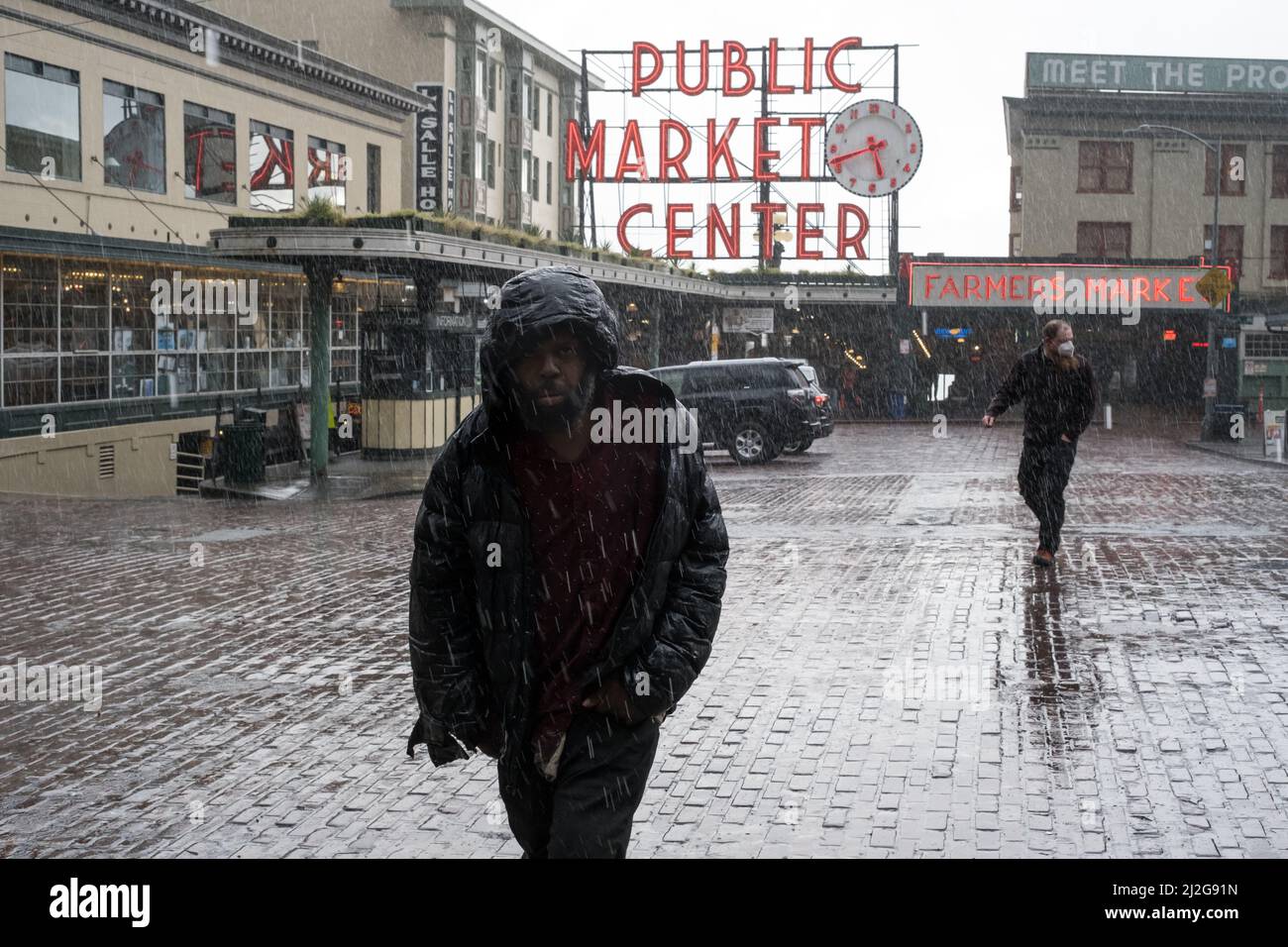Seattle, USA. 30th Mar, 2022. Pike Place Market as a rain storm moves ...