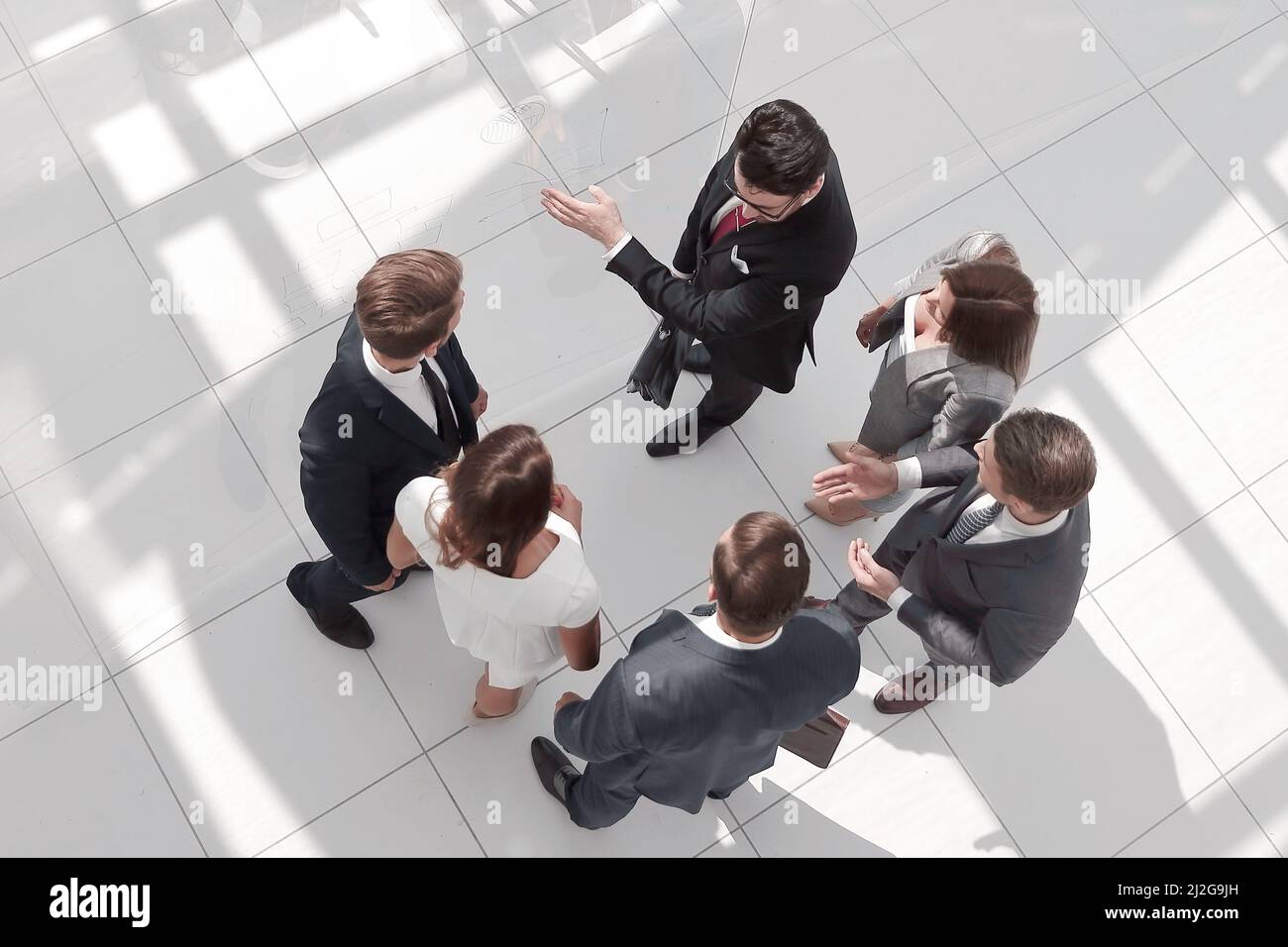 top view. employees standing in a modern office Stock Photo - Alamy