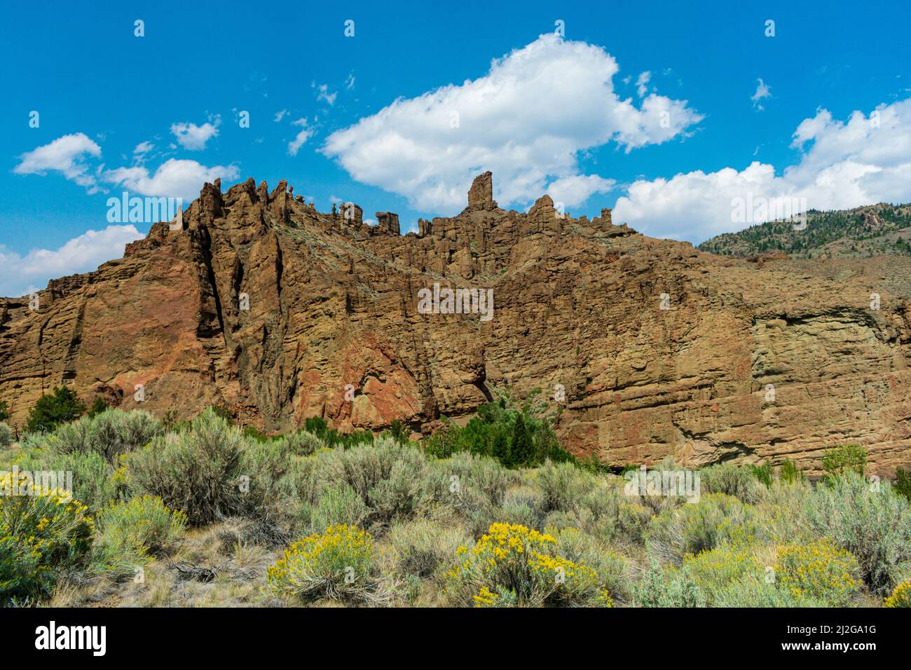 Rock formations high above swift moving river on summer day in the ...