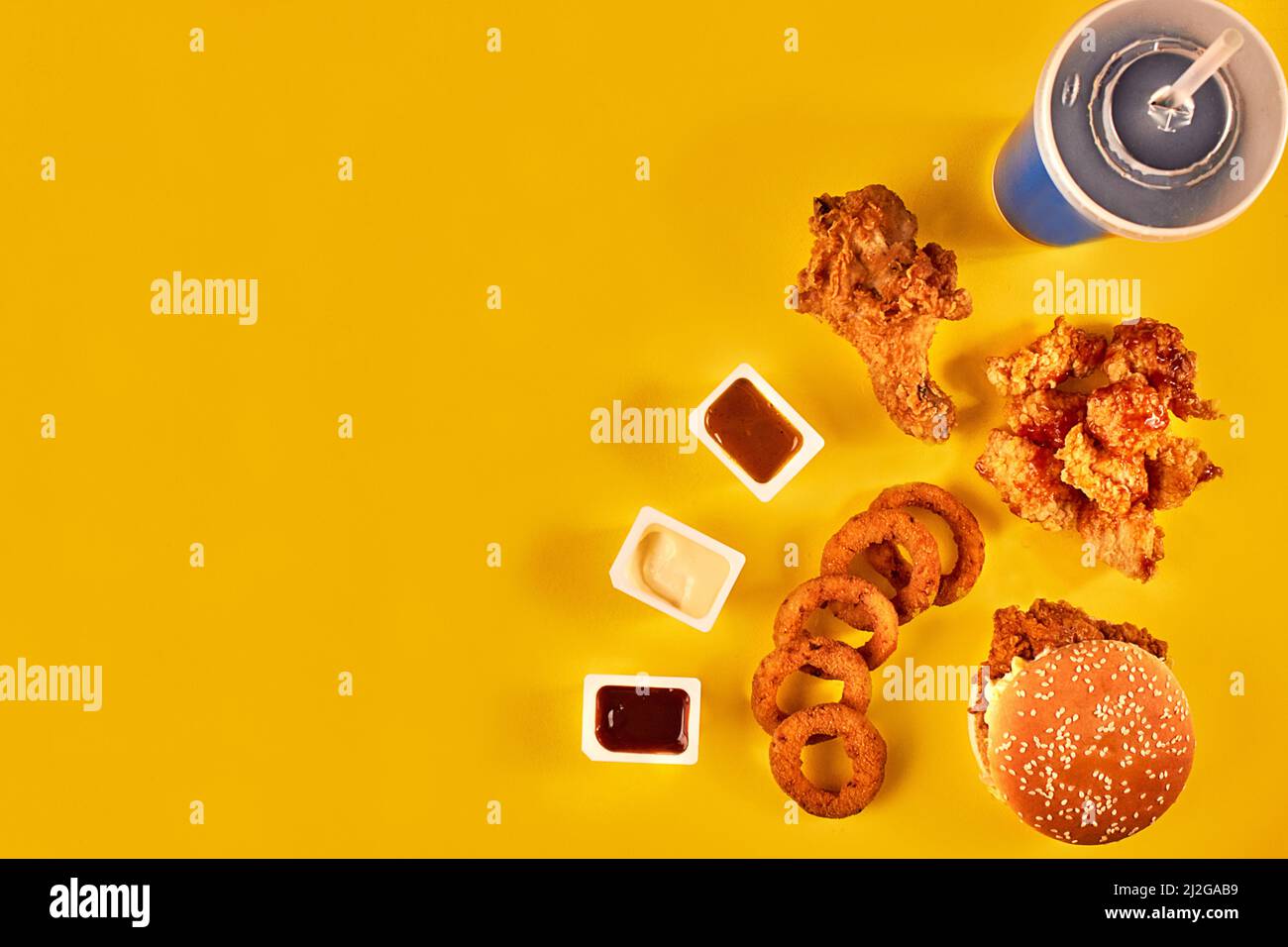 Fast food and unhealthy eating concept - close up of fast food snacks ...