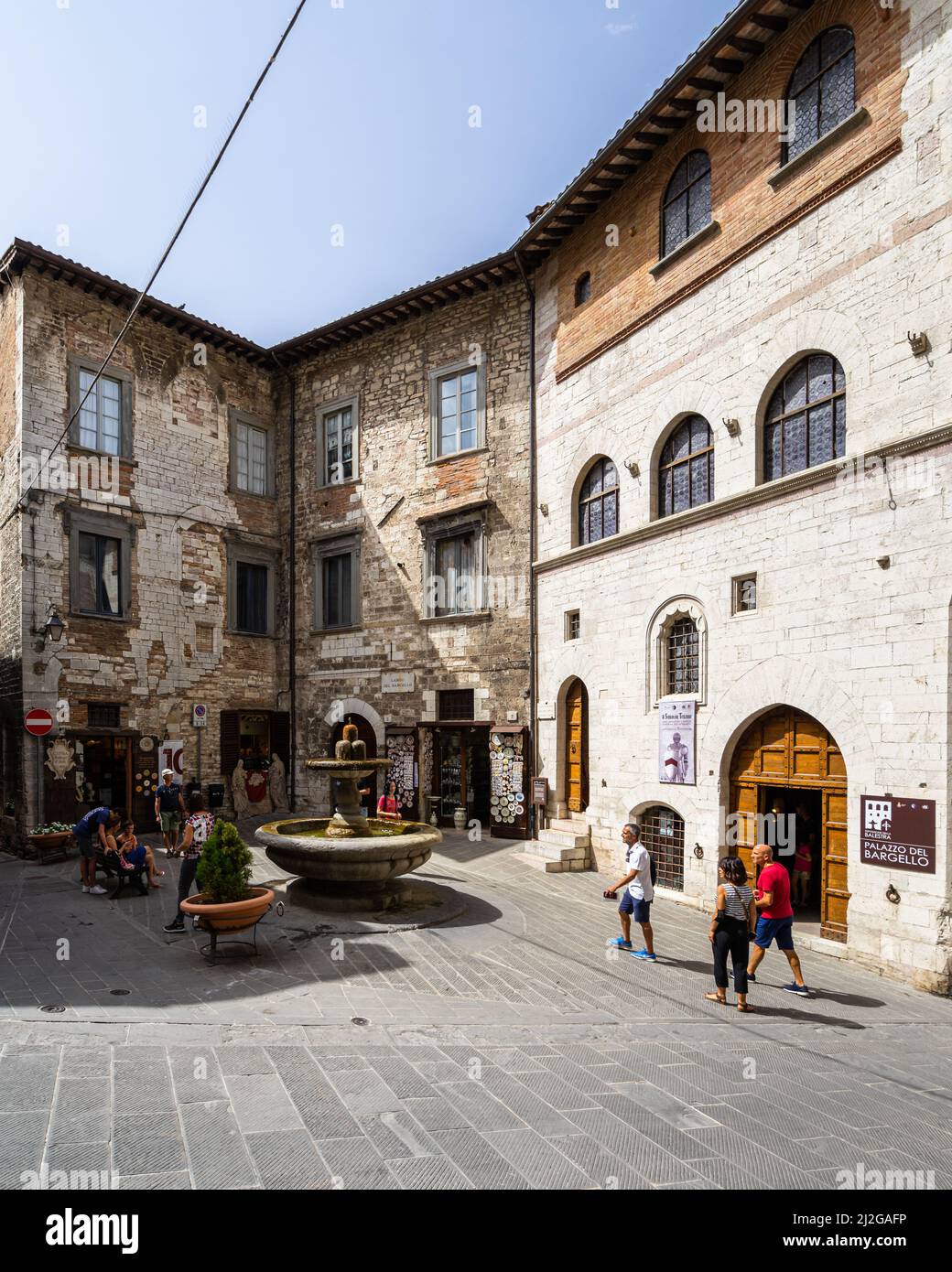 A beautiful shot of people in a street with old medieval buildings in ...