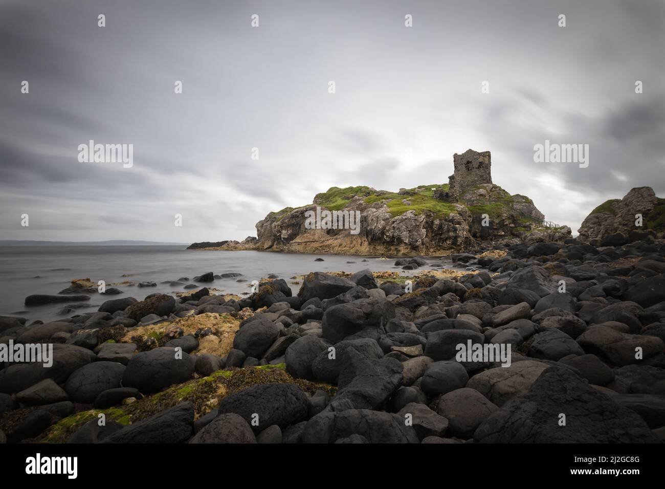 A beautiful view of a ruined building on a small island in the ocean ...