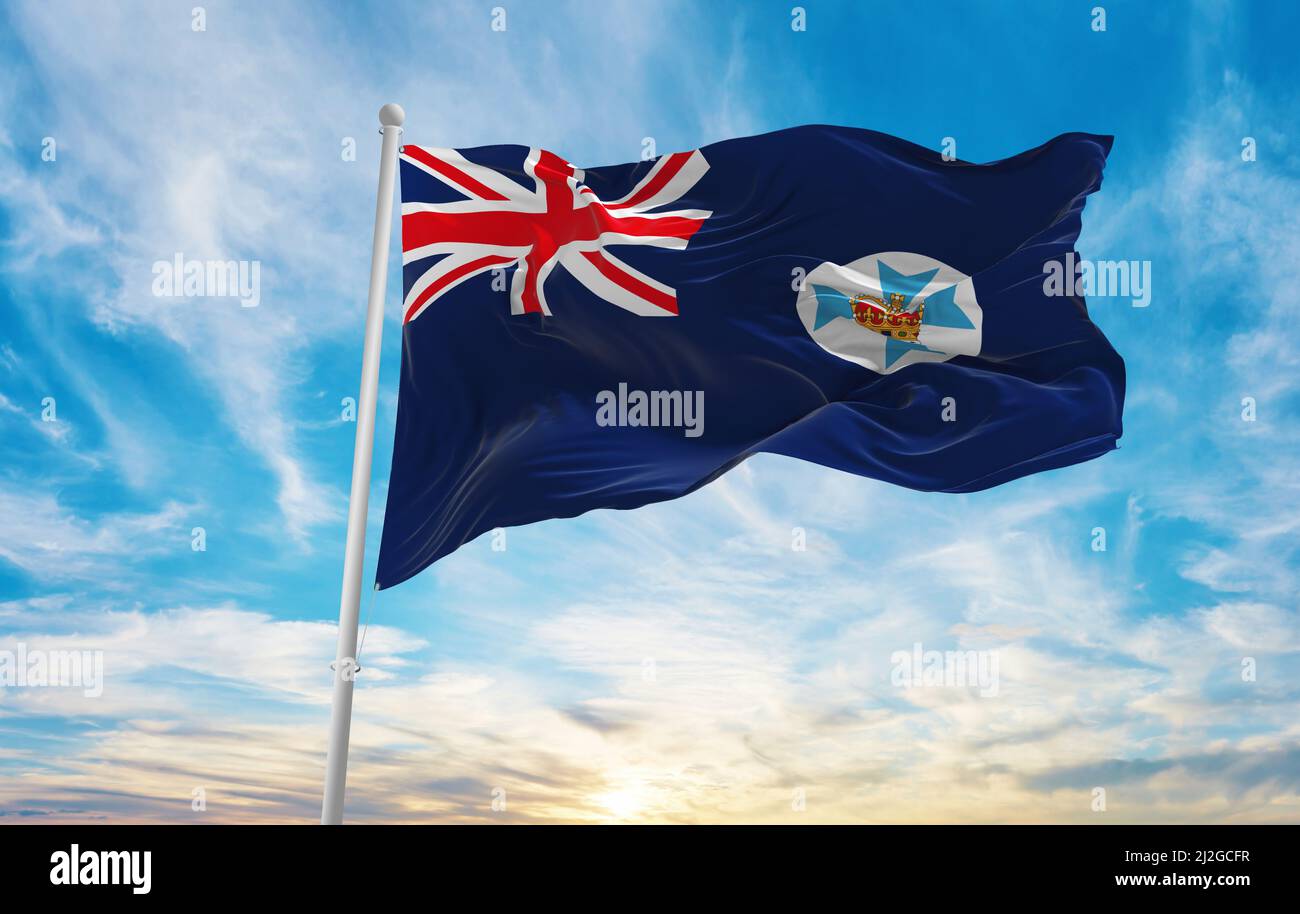 flag of Queensland , Australia at cloudy sky background on sunset ...