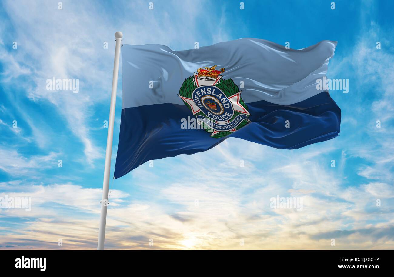 flag of Queensland Police Service , Australia at cloudy sky background ...