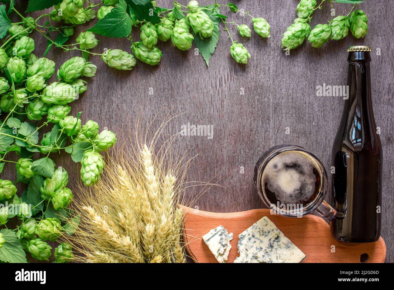 Beer background. Fresh beer and the salty cheese on a wooden table. Top ...