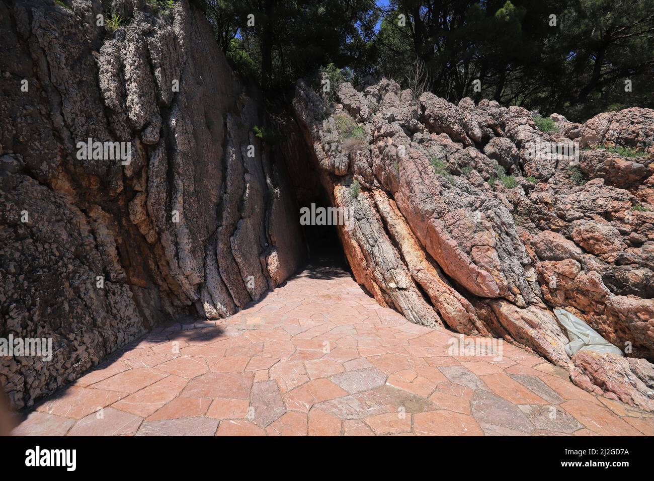 Entrance to a narrow cave in the mountains in Montenegro Stock Photo ...