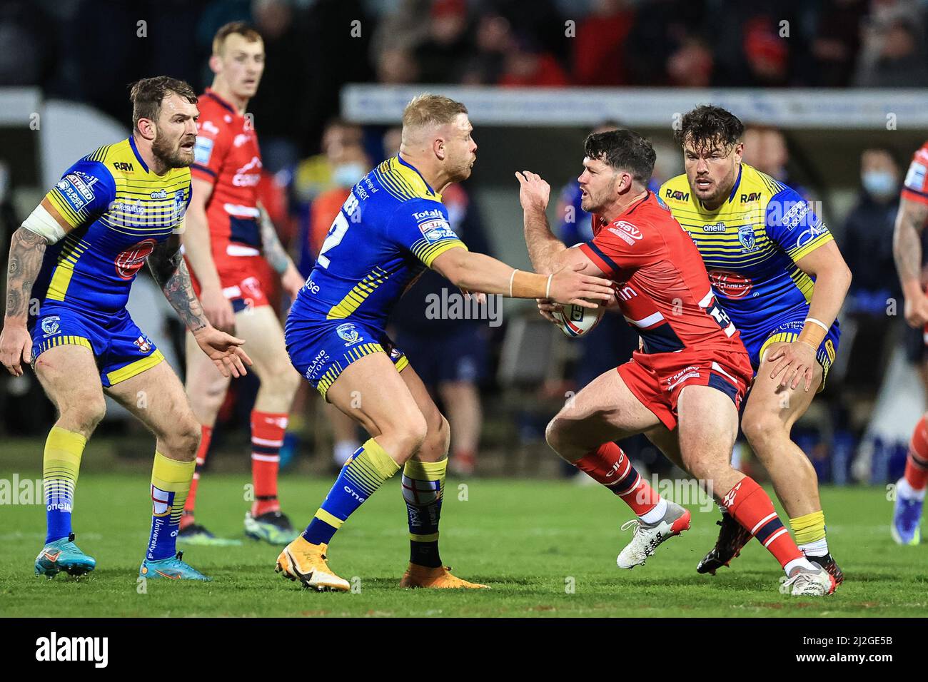 Oliver Holmes #12 of Warrington Wolves stops Lachlan Coote #1 of Hull ...