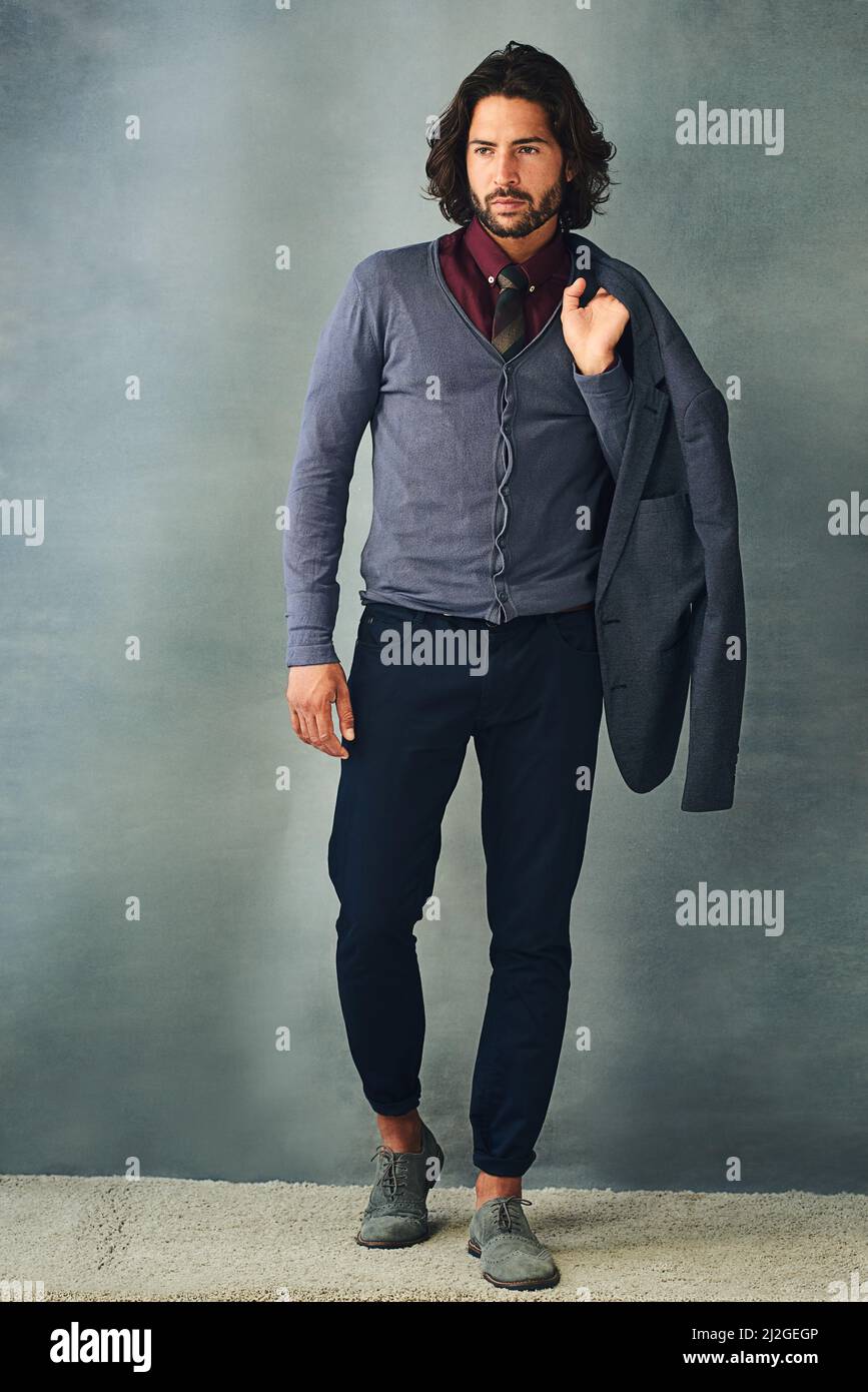 Clothes make the man. Studio shot of a stylishly dressed handsome young ...