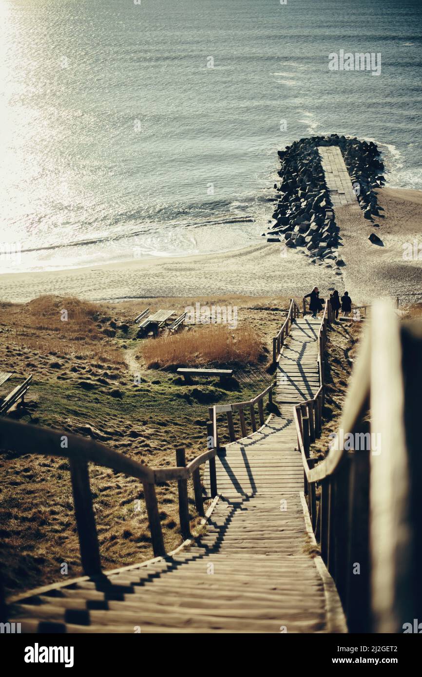 A vertical down view of stairs down to the beach Stock Photo - Alamy