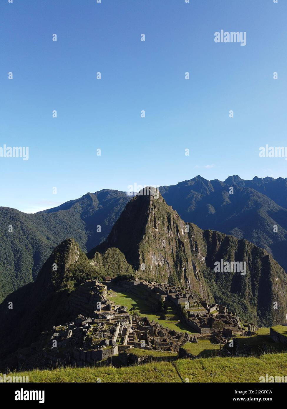A vertical shot of the ancient Machu Picchu citadel in the Eastern ...