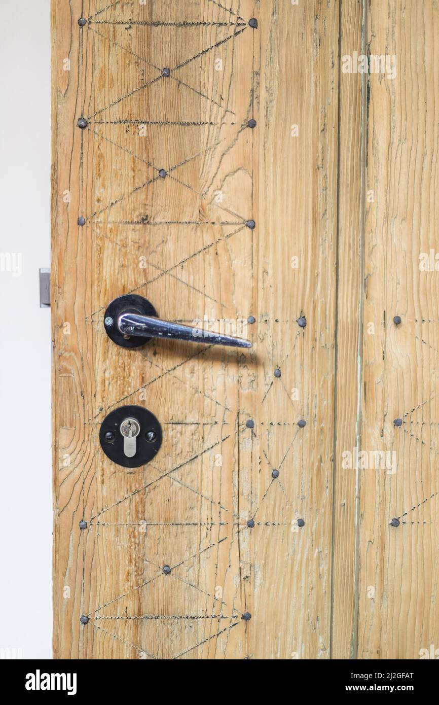 The detail of a wooden door with nails and scratches on the surface ...