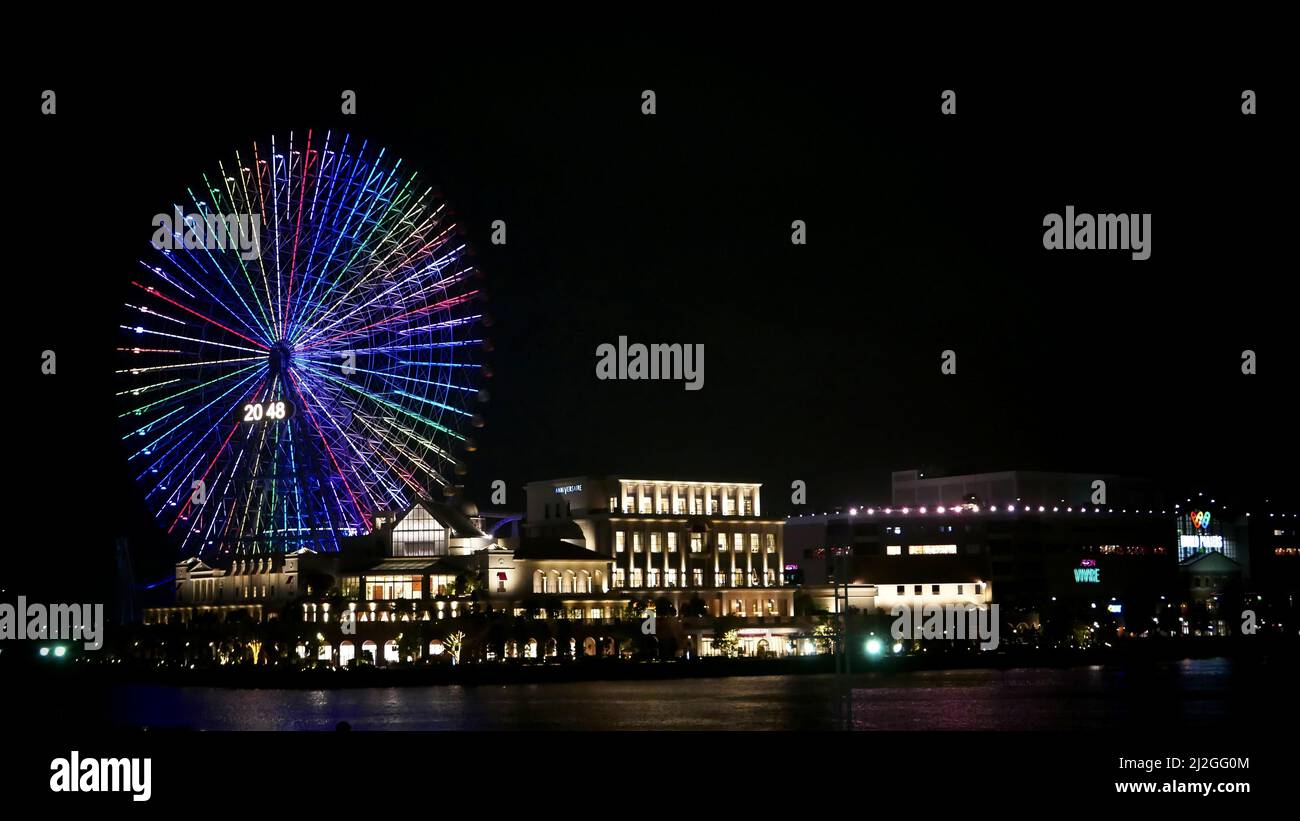 A Beautiful night shot of Cosmo Clock 21 Ferris wheel with colorful ...