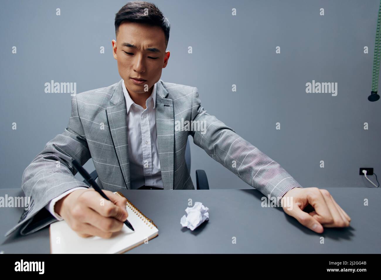 Asian man sits in the office emotions nervous breakdown anger isolated ...