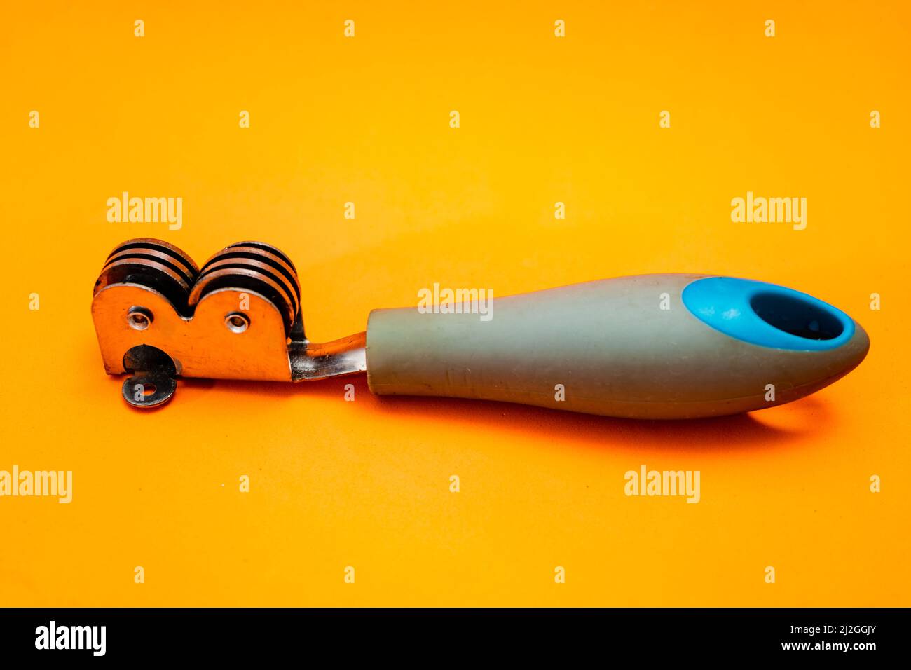 Knife sharpener isolated on an orange background. Inexpensive non ...