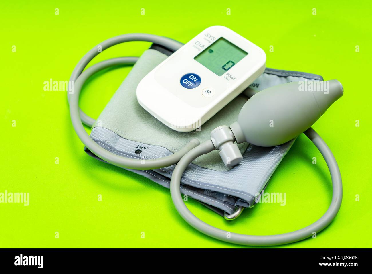 Automatic blood pressure monitor or blood pressure meter on green ...