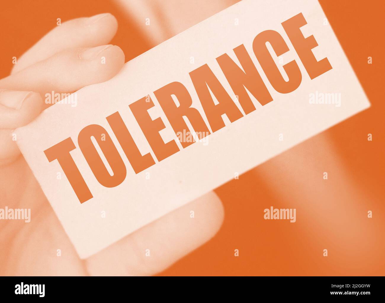 Tolerance words on a card in businessman hand. Social concept against ...