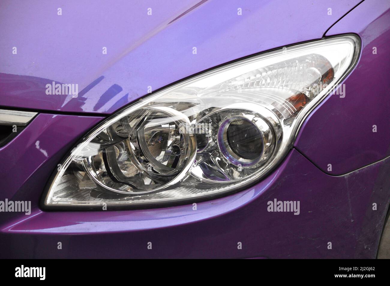 Detail of car headlights lamp, purple modern a luxury car front lamp ...