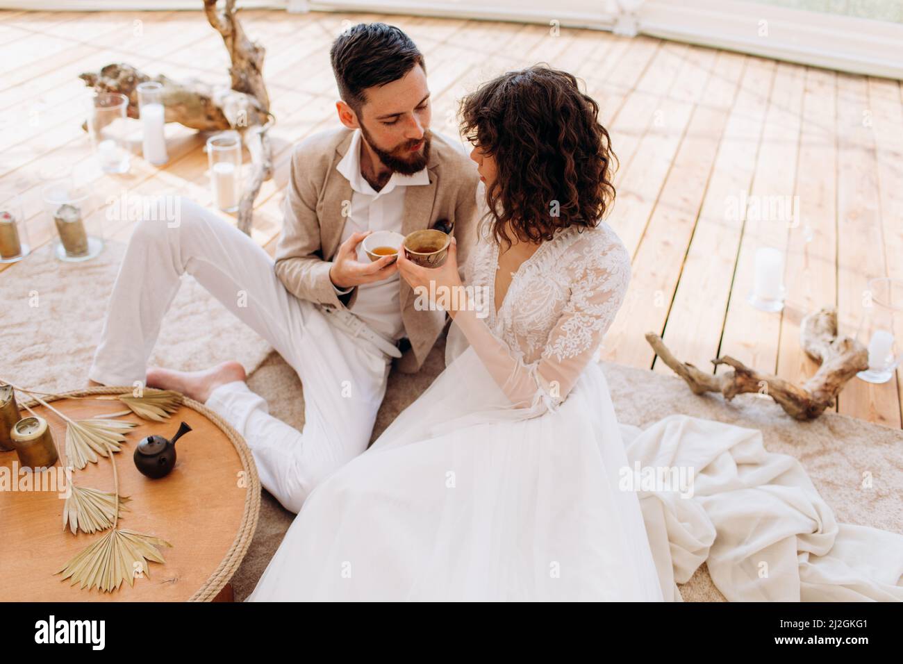 Tea ceremony at a boho wedding. Bride and groom in boho Stock Photo - Alamy